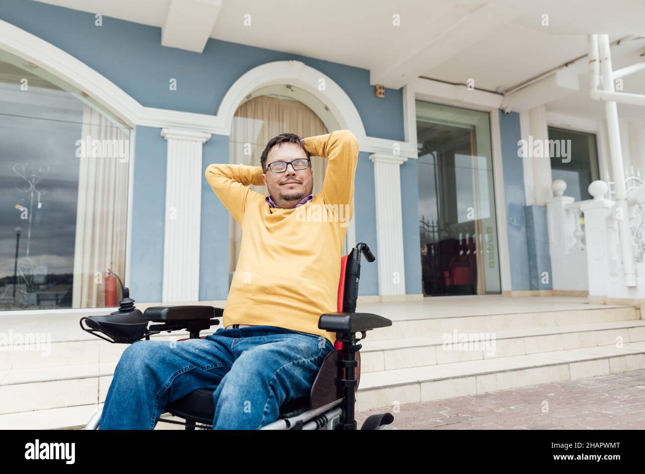 a man with disabilities in a wheelchair enjoys life Stock Photo - Alamy