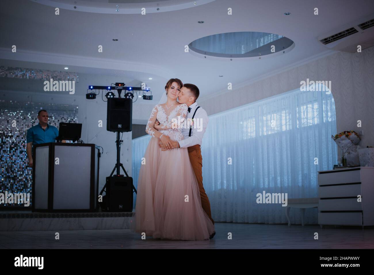 beautiful caucasian couple just married and dancing their first dance ...