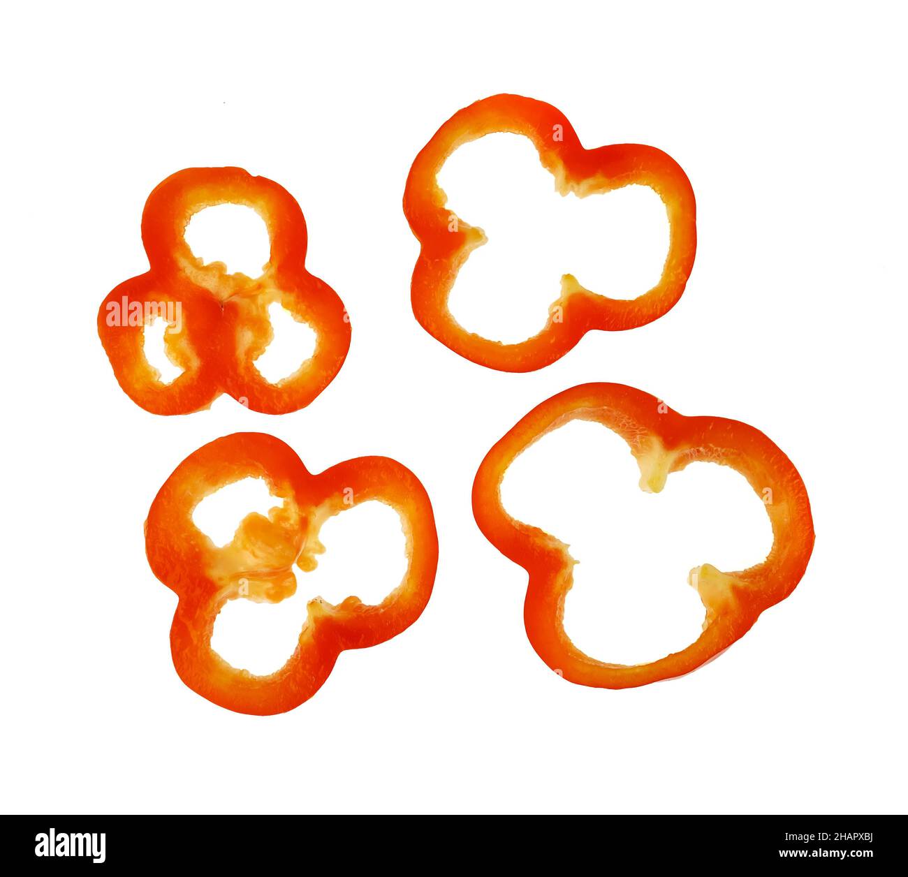 ripe sweet red pepper, cut into pieces, top view on a white background ...