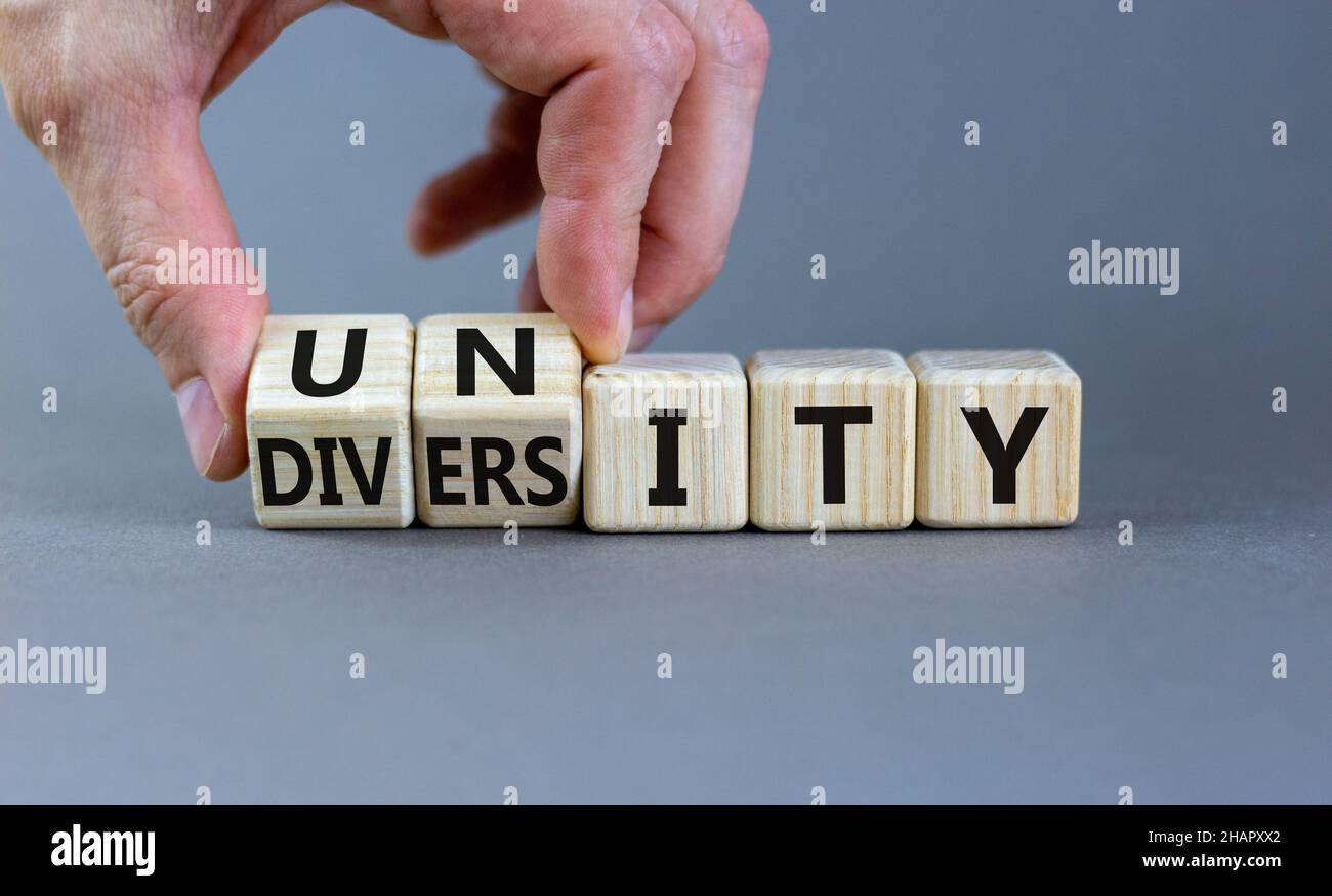Diversity and unity symbol. Businessman turns wooden cubes and changes ...