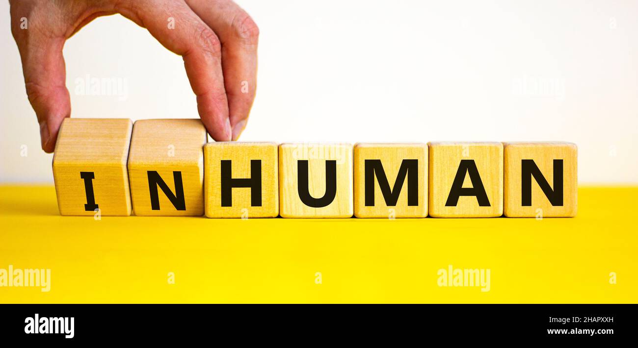 Human or inhuman symbol. Businessman turns wooden cubes and changes the ...