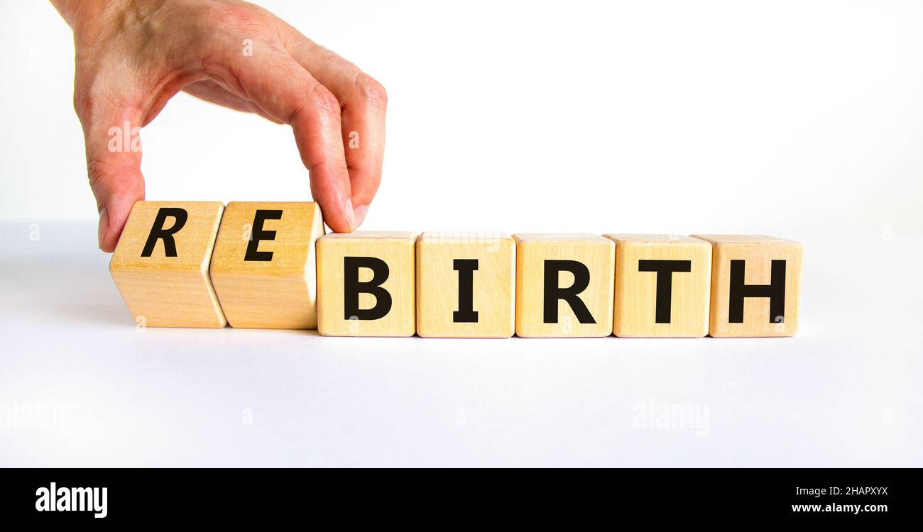 Birth or rebirth symbol. Businessman turns wooden cubes and changes the ...