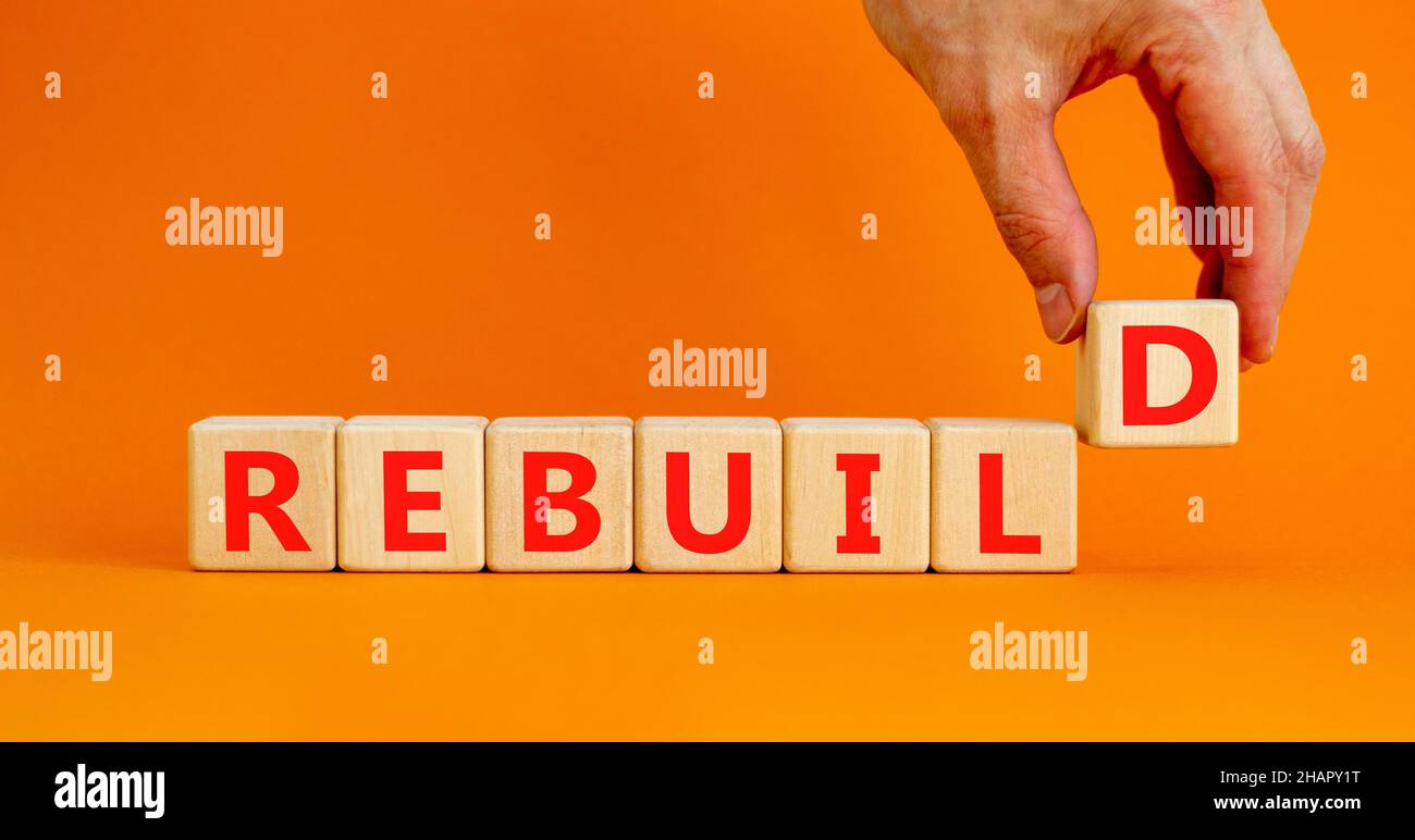Rebuild and build symbol. The concept word Rebuild on wooden cubes ...