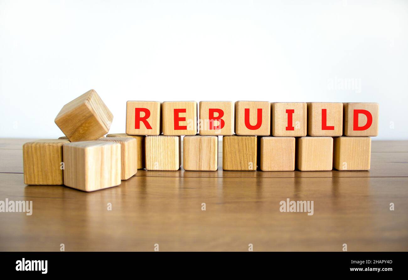 Rebuild and build symbol. The concept word Rebuild on wooden cubes ...
