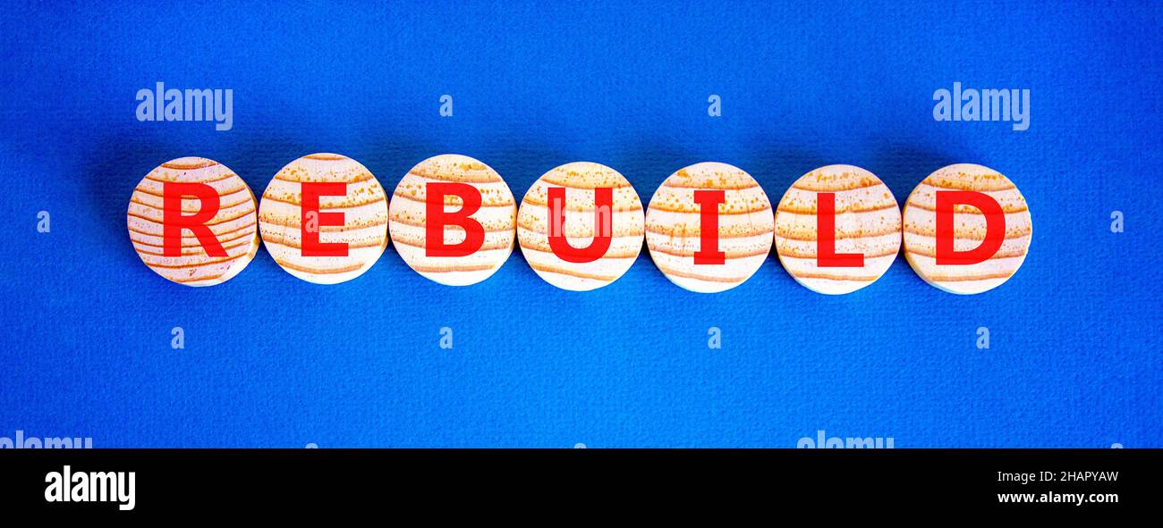 Rebuild and build symbol. The concept word Rebuild on wooden circles ...