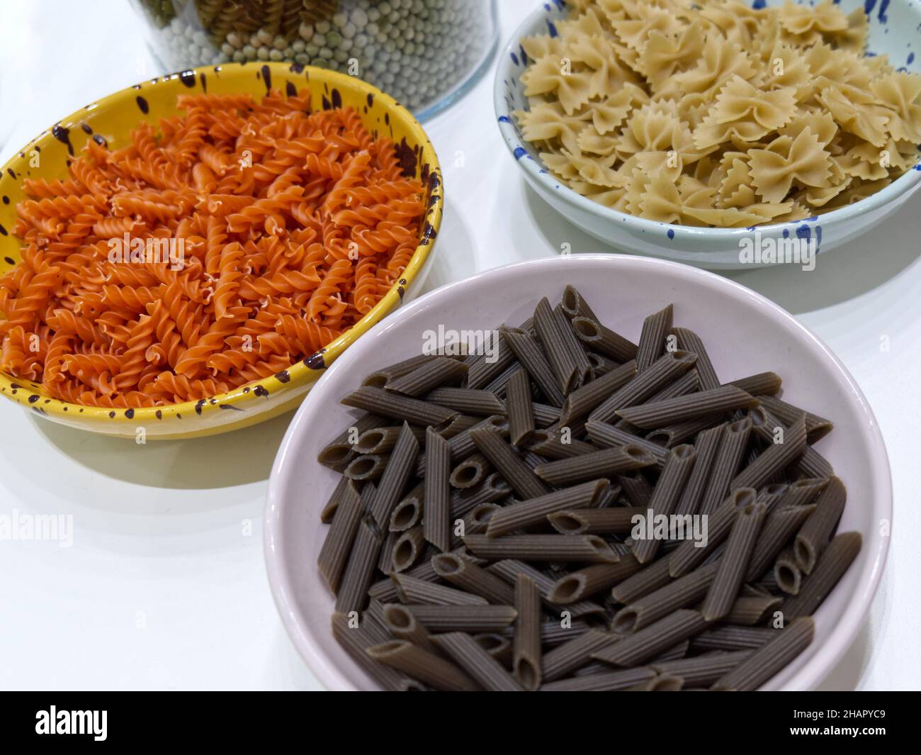 three bowls of flavored Italian pasta ready to cook Stock Photo - Alamy