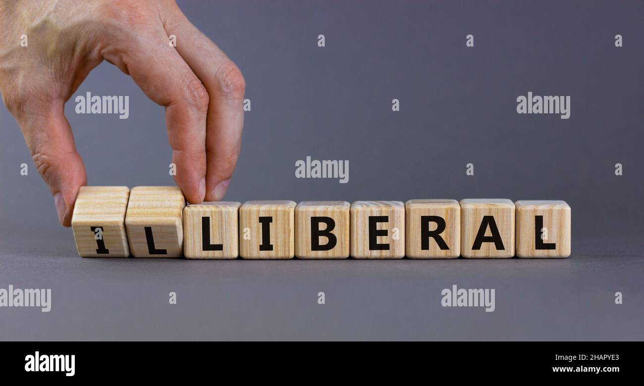 Illiberal or liberal symbol. Businessman turns wooden cubes and changes ...