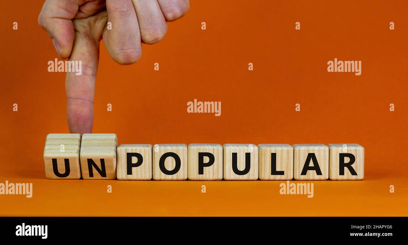 Popular or unpopular symbol. Businessman turns wooden cubes and changes ...