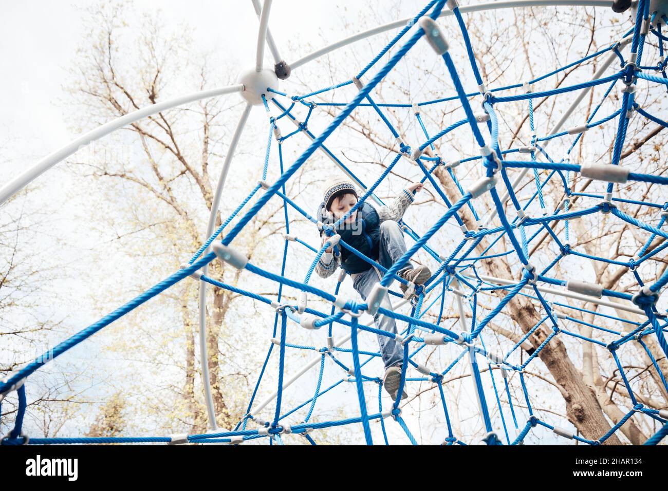 beautiful little boy playing in a rope maze Stock Photo - Alamy