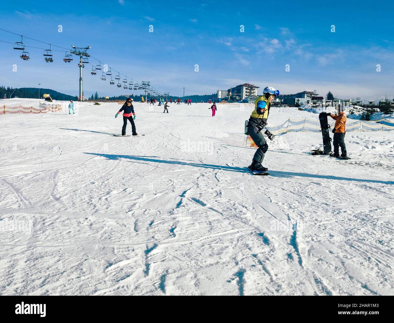 Bukovel, Ukraine - December 14, 2019: woman riding on snowboard down by ...