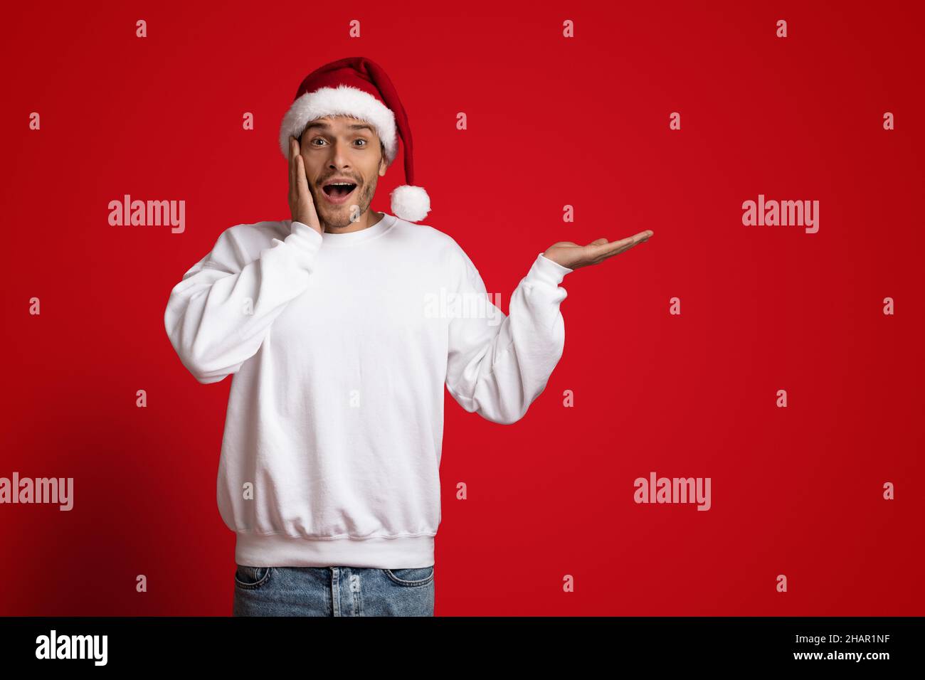 Holiday Offer. Excited Guy In Santa Hat Pointing Aside With Open Palm ...