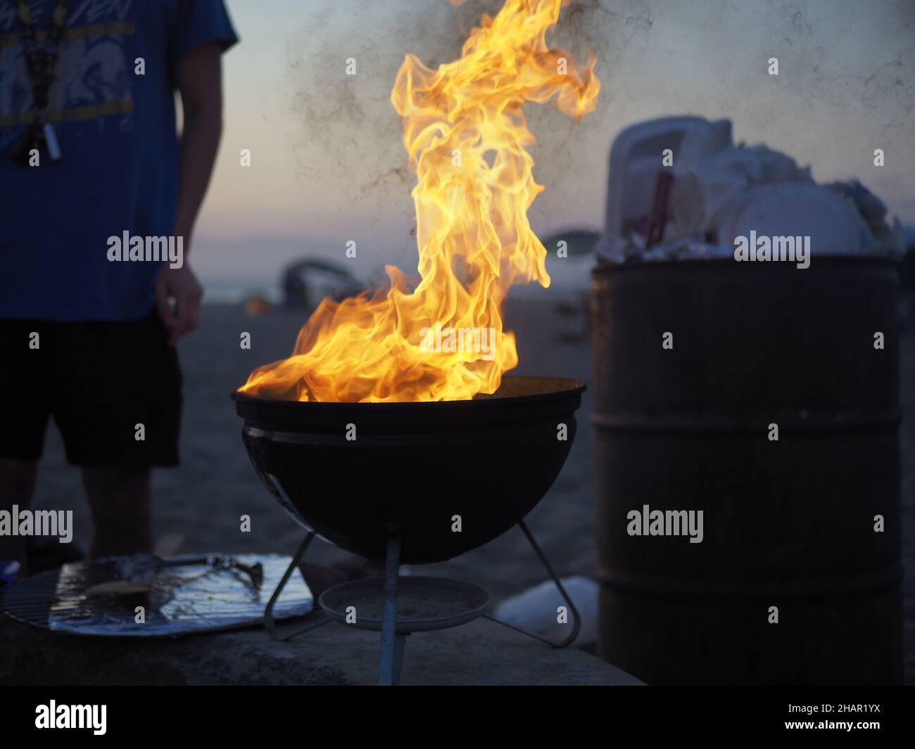 Bonfire in a bowl near the garbage bin on the beach Stock Photo - Alamy