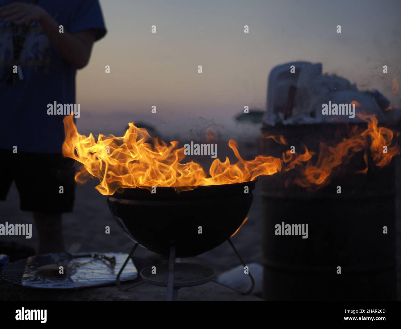 Bonfire in a bowl near the garbage bin on the beach Stock Photo - Alamy