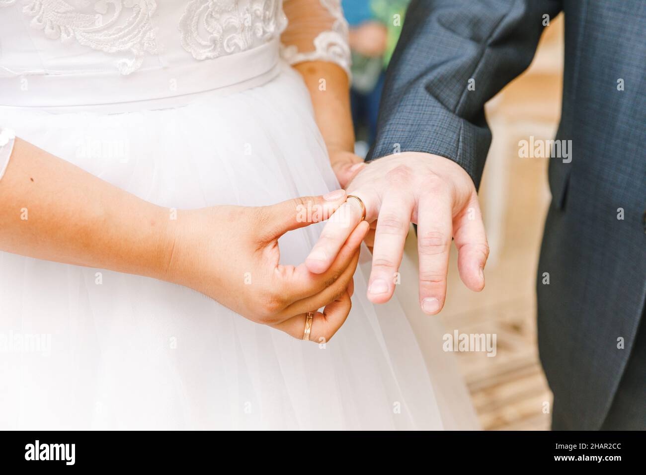 Bride and groom marriage hands with wedding rings. Bride hand putting ...