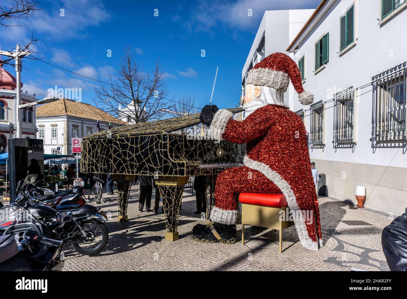 A gigantic Santa Claus playing his equally gigantic piano near the ...