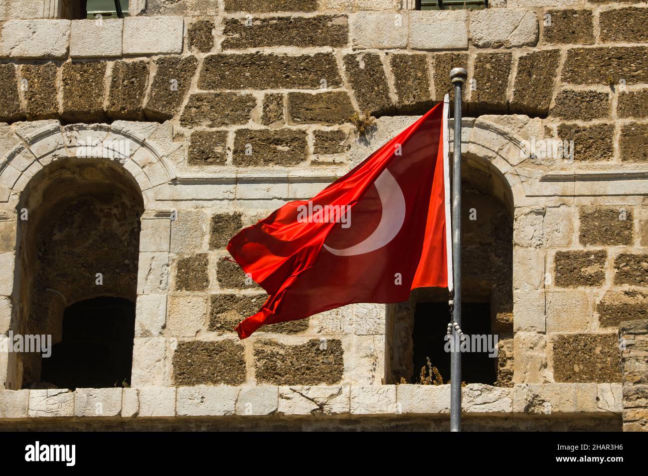 Turkish flag waving in front of the Ancient Theater of Aspendos-Antalya ...