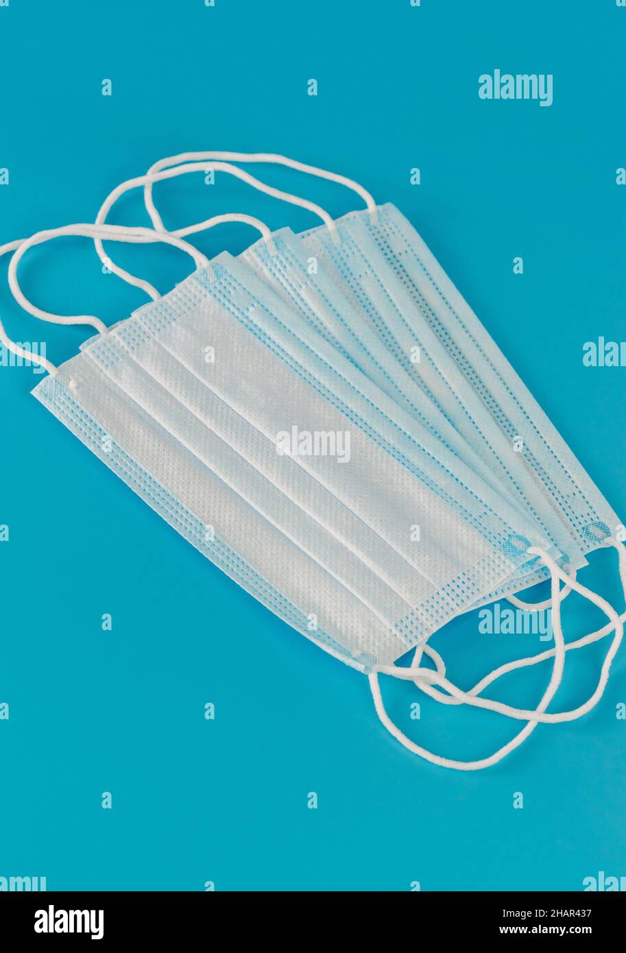 Four new medical surgical facial three-layer masks lie side by side on ...