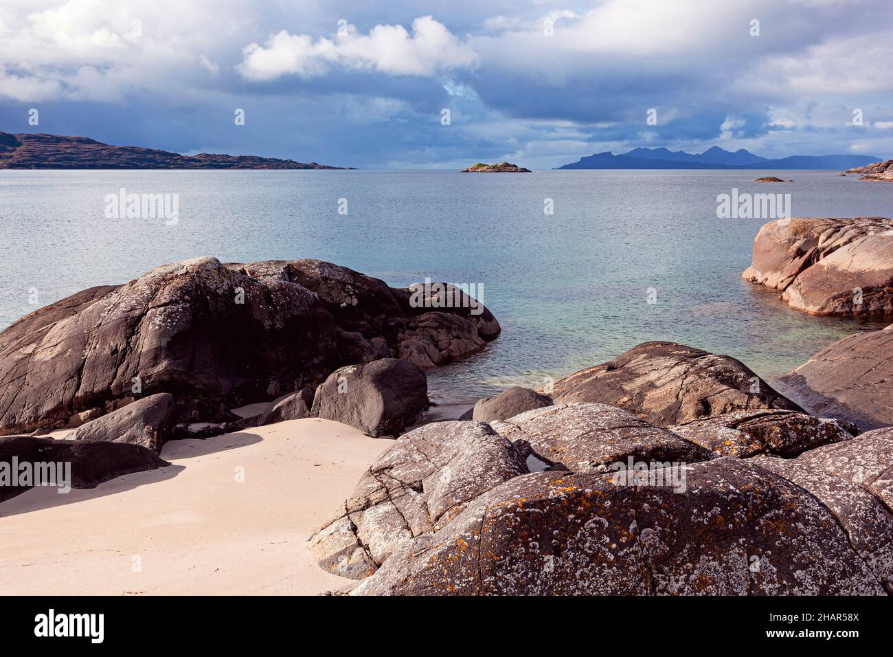 Mottled boulders on one of the white sand beaches at Ardtoe with views ...