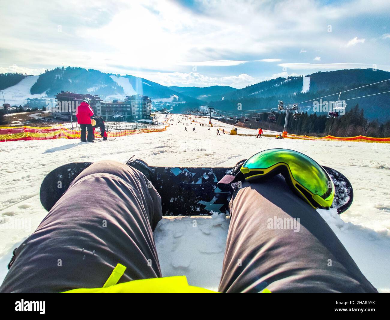 snowboarding concept sitting on the hill people skiing down copy space ...