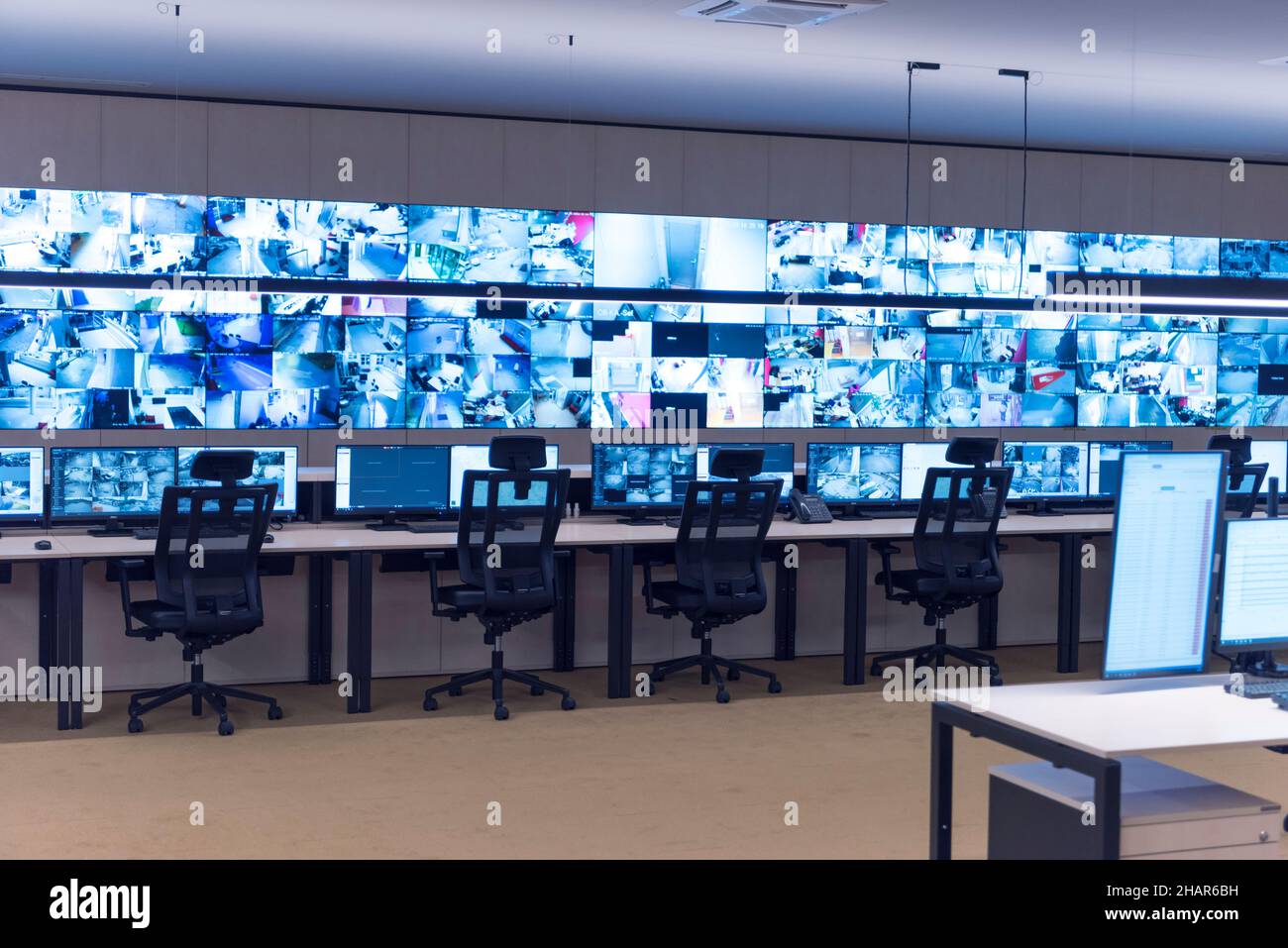Security guard monitoring modern CCTV cameras in surveillance room ...