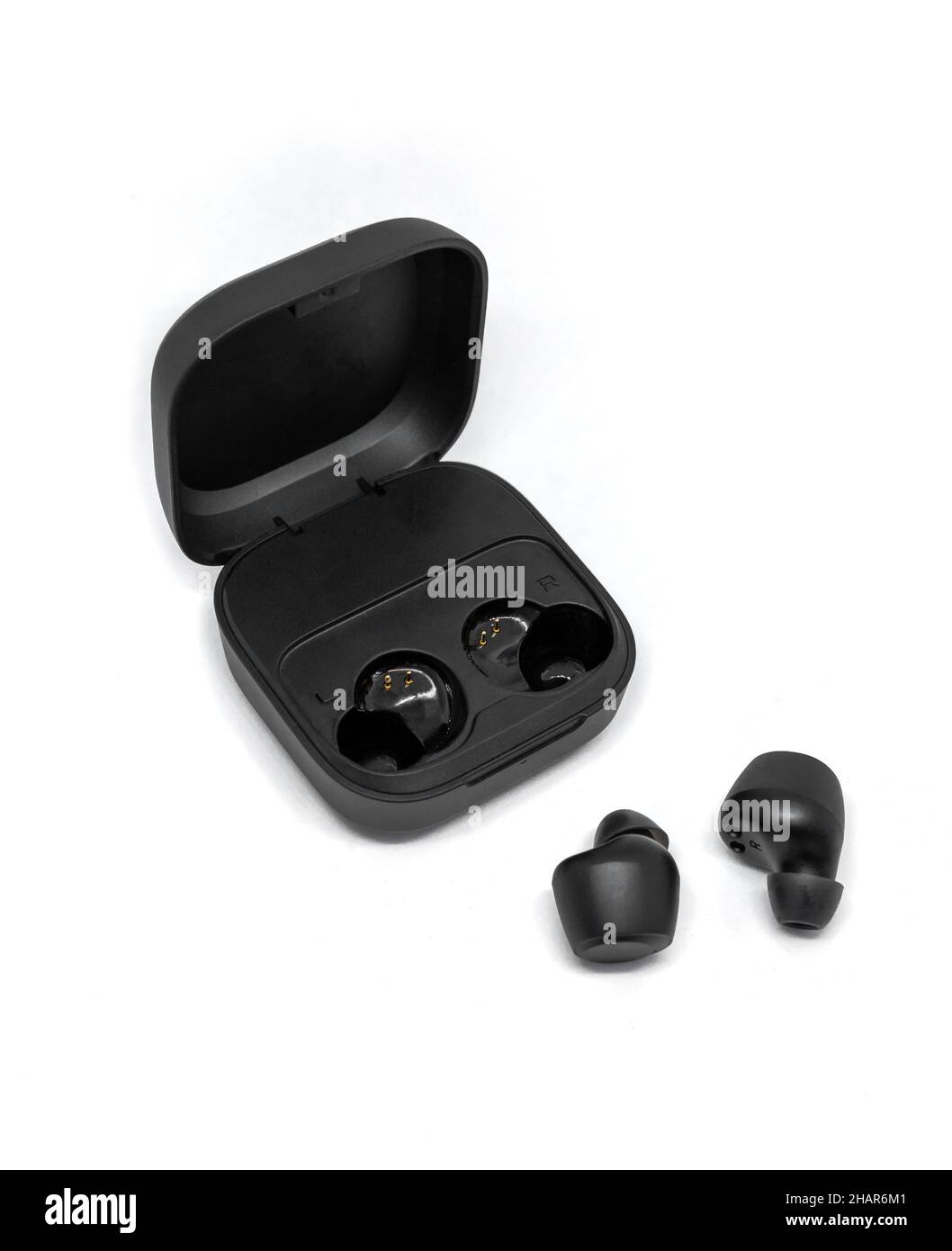 Black wireless bluetooth headphones and power bank isolated on white ...