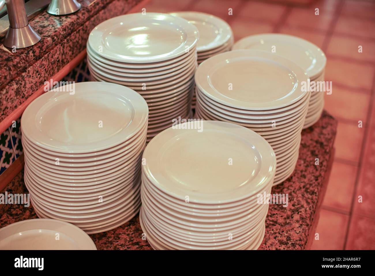 Clean white plates ready at table in buffet restaurant Stock Photo - Alamy