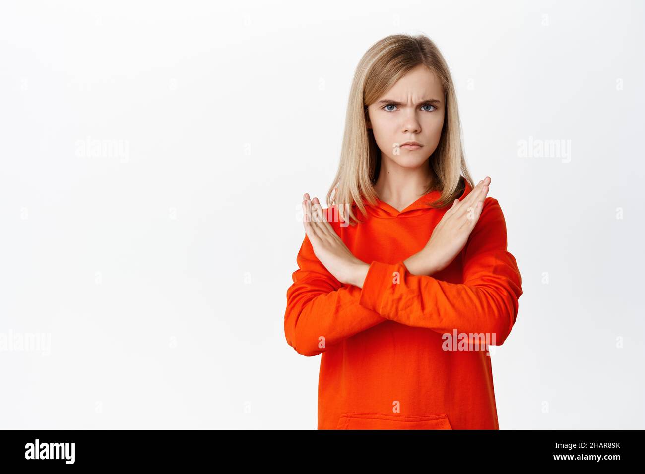Teen blond girl showing cross, stop rejection gesture, prohibit smth ...