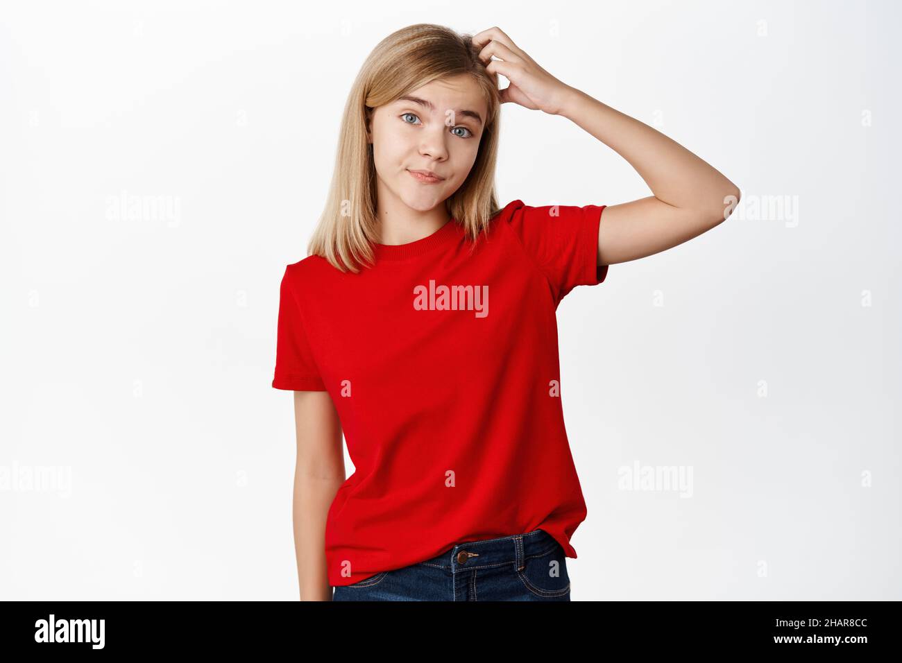 Confused little girl scratched her head and looks puzzled, dont know ...