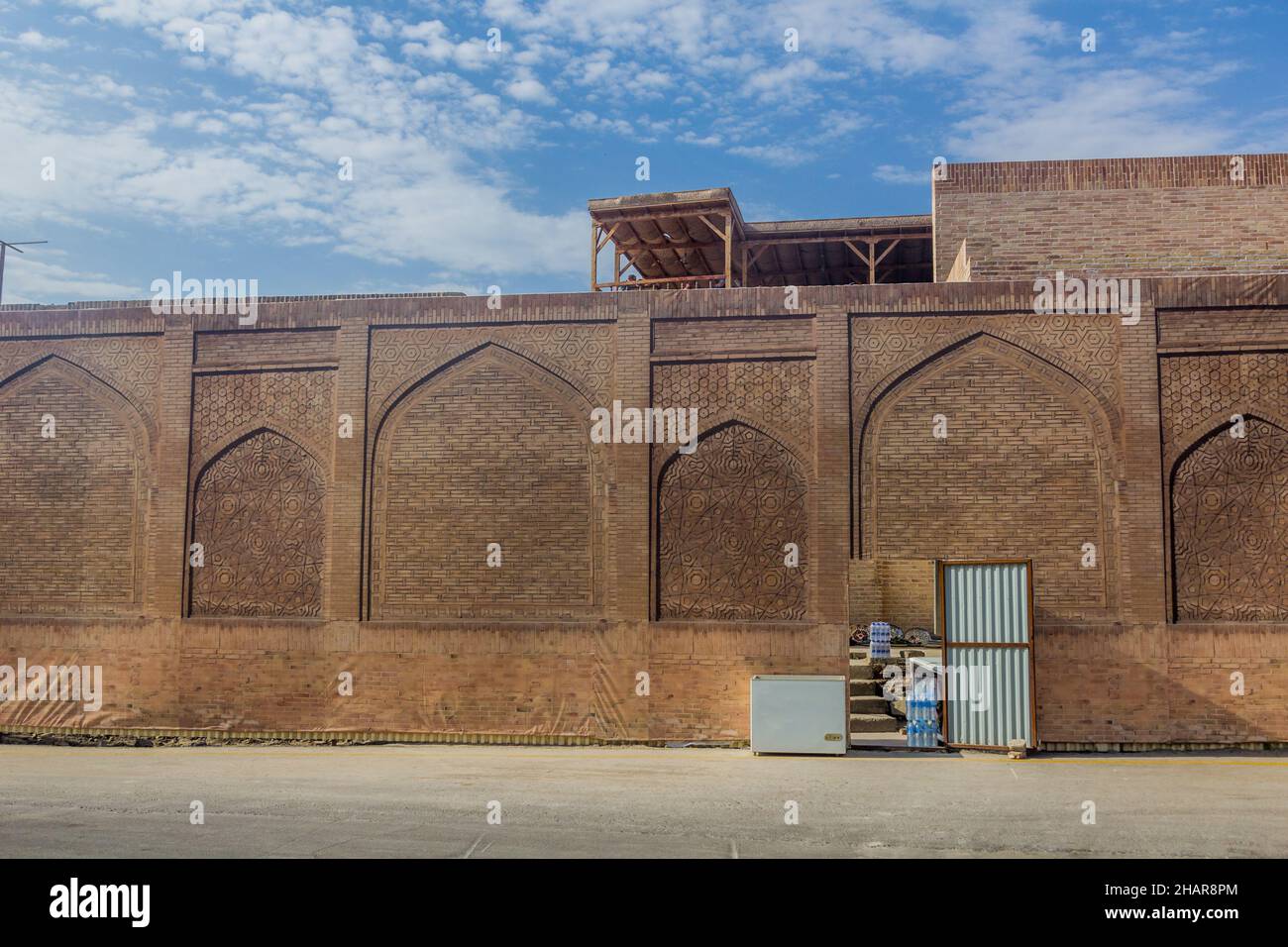 Wall separating historical sights and living neighborhoods in Bukhara ...