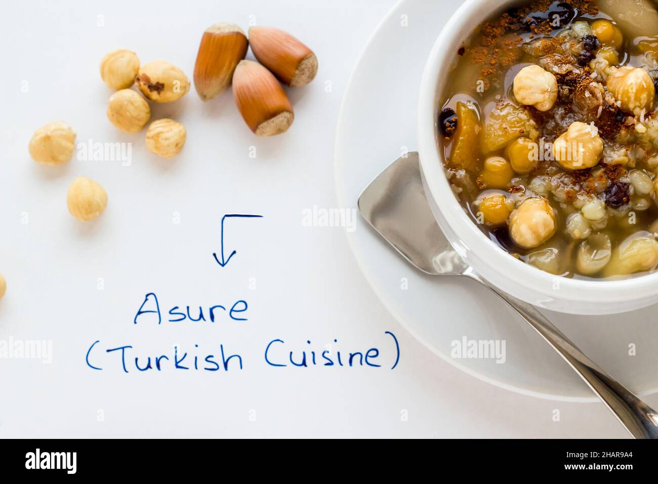 Traditional Turkish dish Asure Noah's Pudding in white bowl with ...