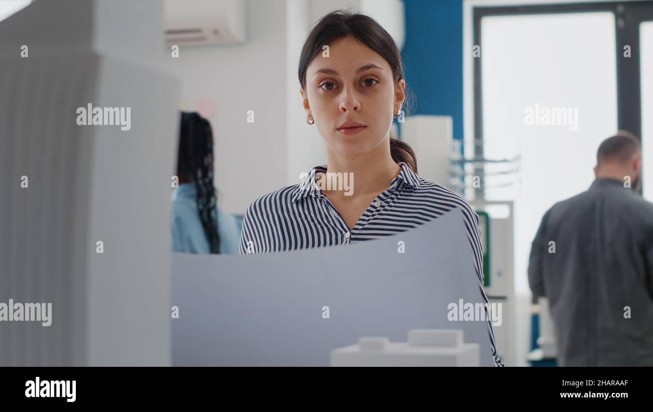 Portrait Of Architect Analyzing Blueprints Plan To Work On Construction