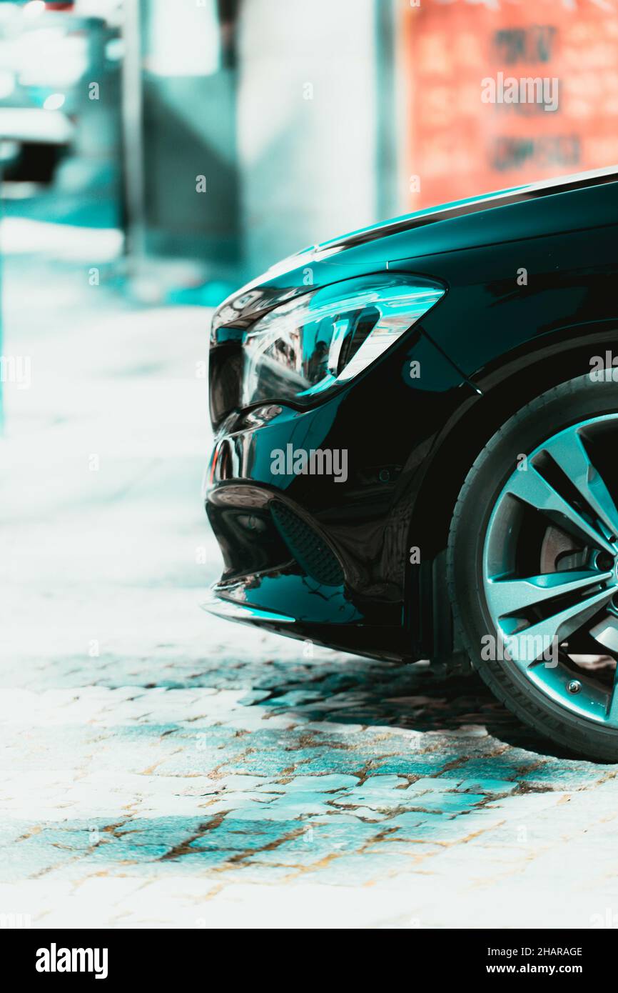 Front part of a modern black car parked outside Stock Photo - Alamy