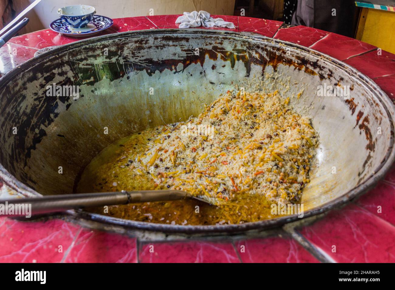Cooking of plov in the Kazan cauldron in Tashkent, Uzbekistan Stock ...