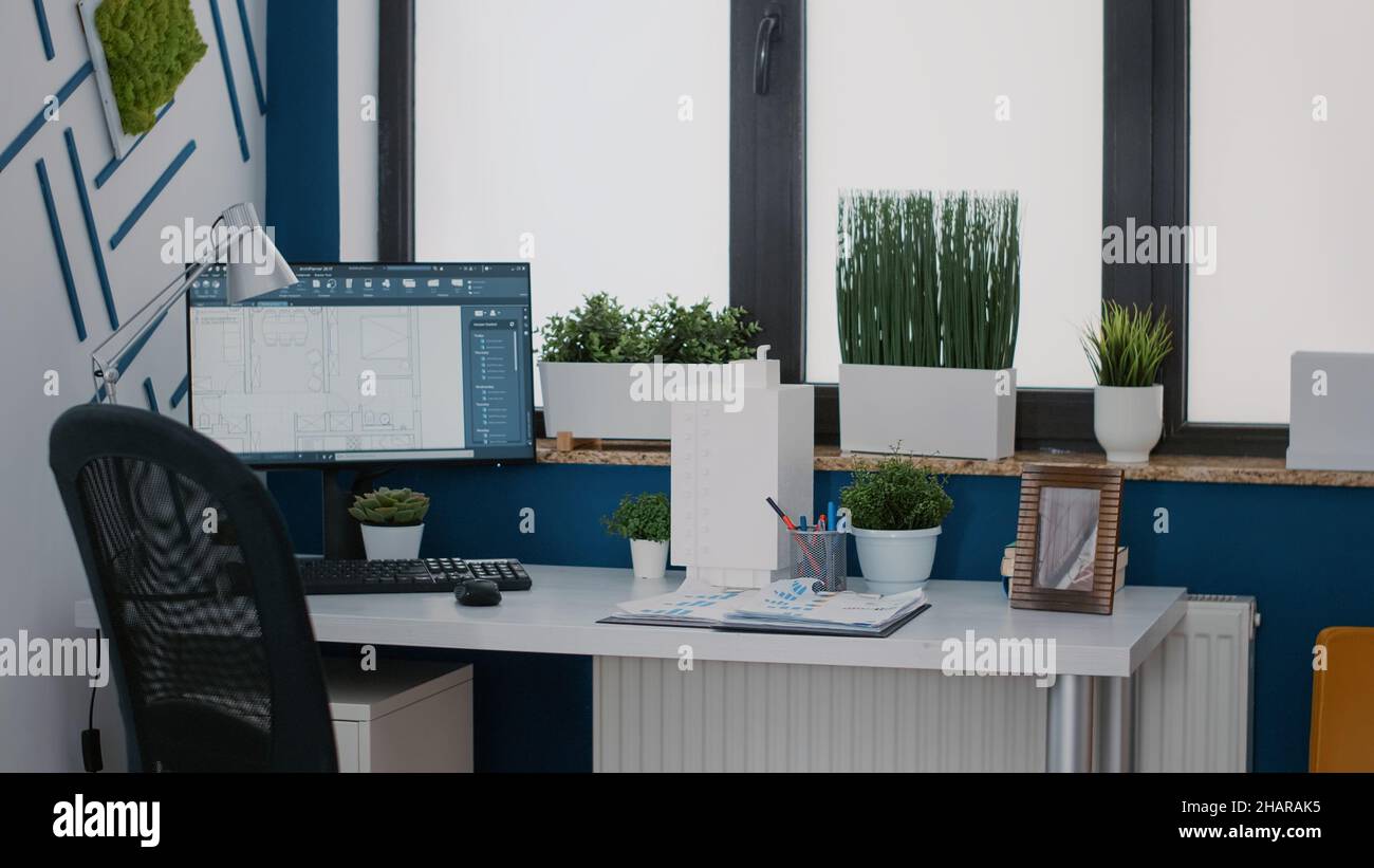 Close up of monitor with digital blueprints plans on desk for ...