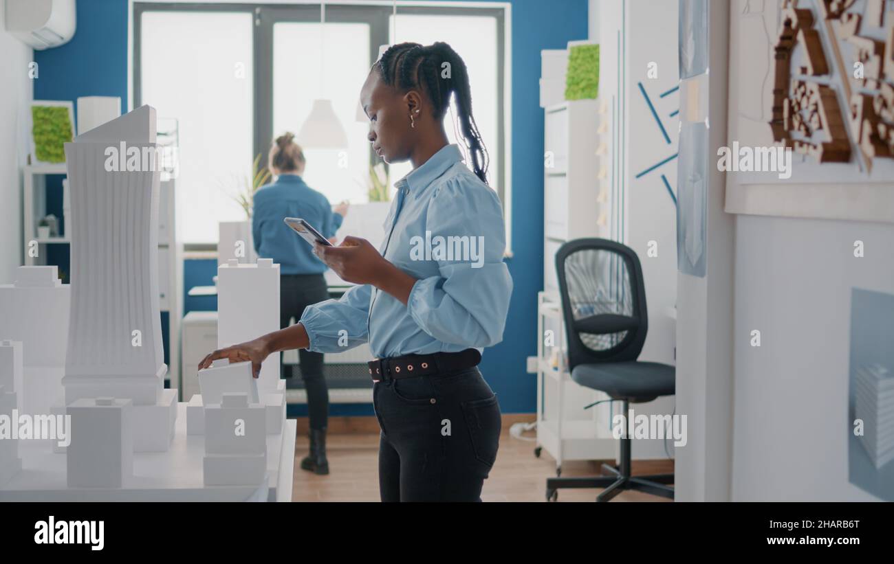 Modern engineer using mobile phone to design construction layout with ...