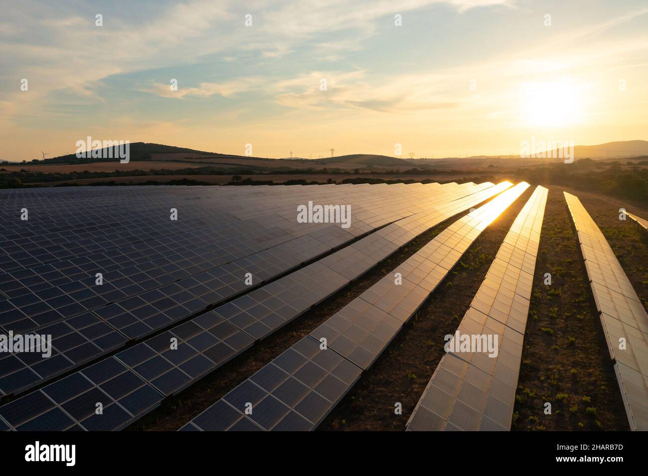Solar panel farm under sunset sky reflecting light Stock Photo - Alamy