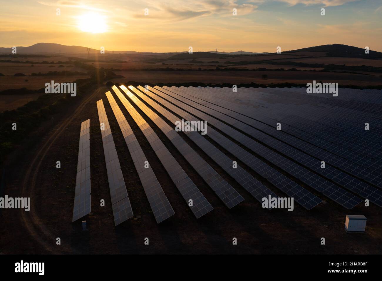 Solar panel farm under sunset sky reflecting light Stock Photo - Alamy