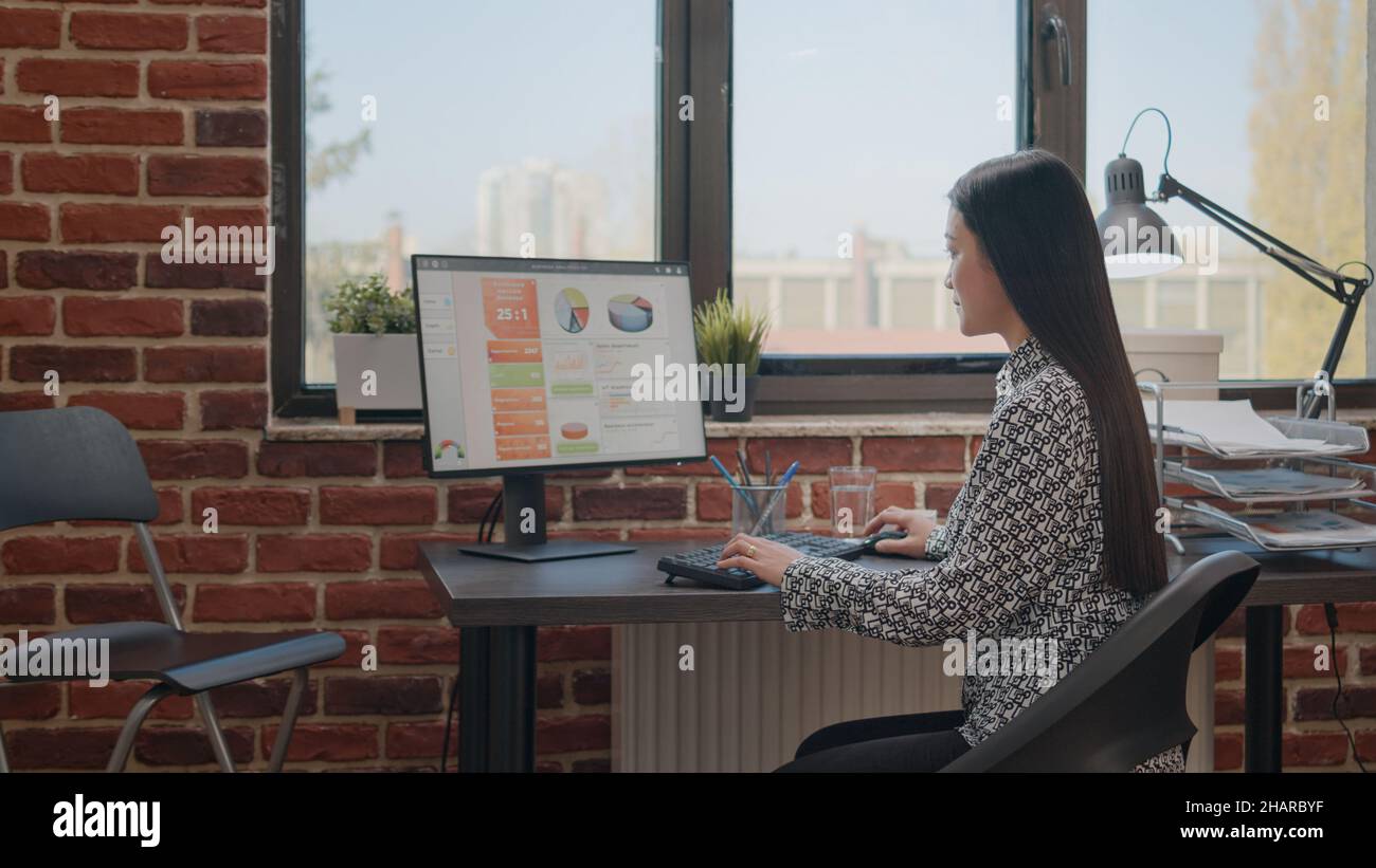 Employee using computer to work on startup business plan, brainstorming ...