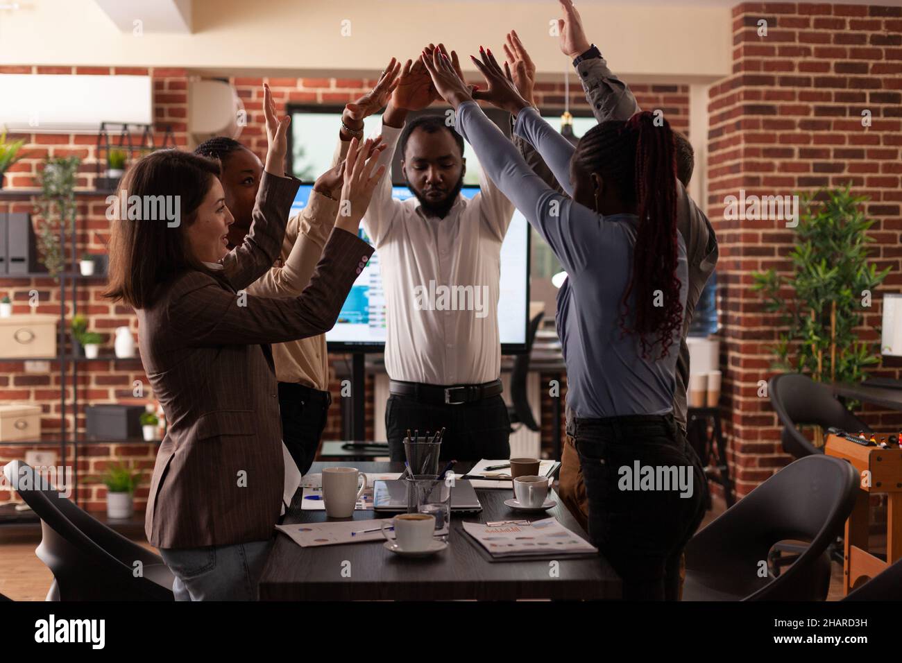 Successful excited diverse businesspeople celebrating winning business ...