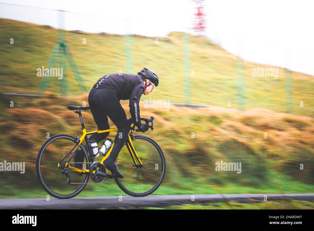 Pan shot of a young caucasian cyclist man sprinting on his bike Stock ...