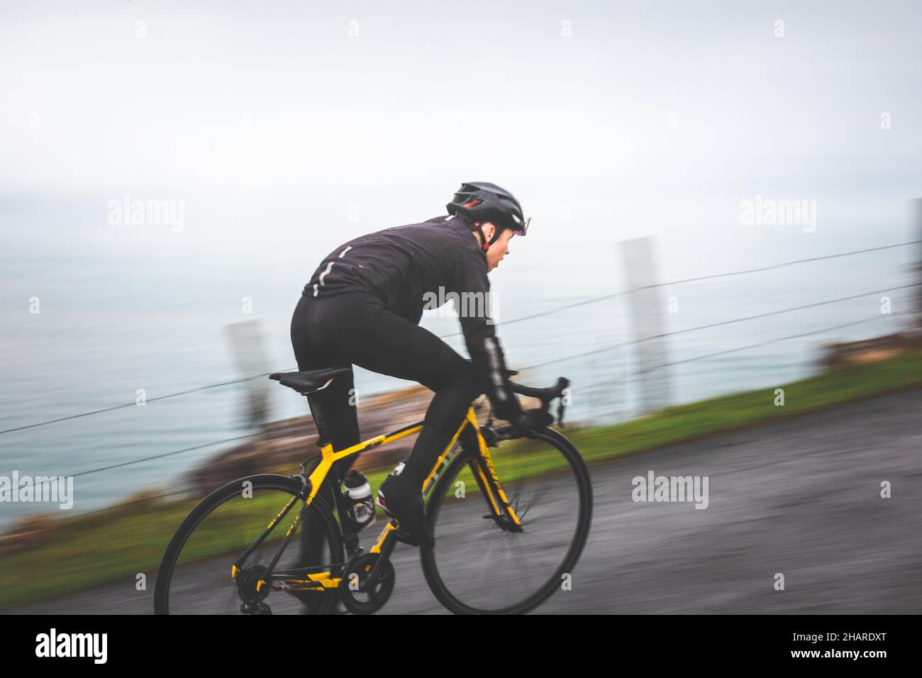 Pan shot of a young caucasian cyclist man sprinting on his bike Stock ...