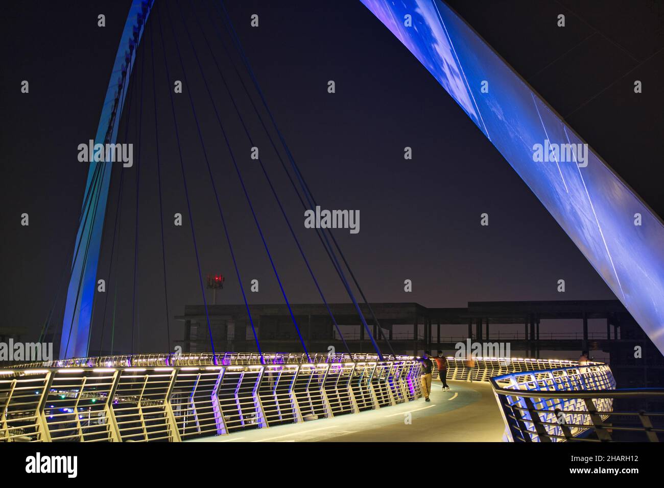 Dubai Water Canal pedestrian bridge in United Arab Emirates at night ...