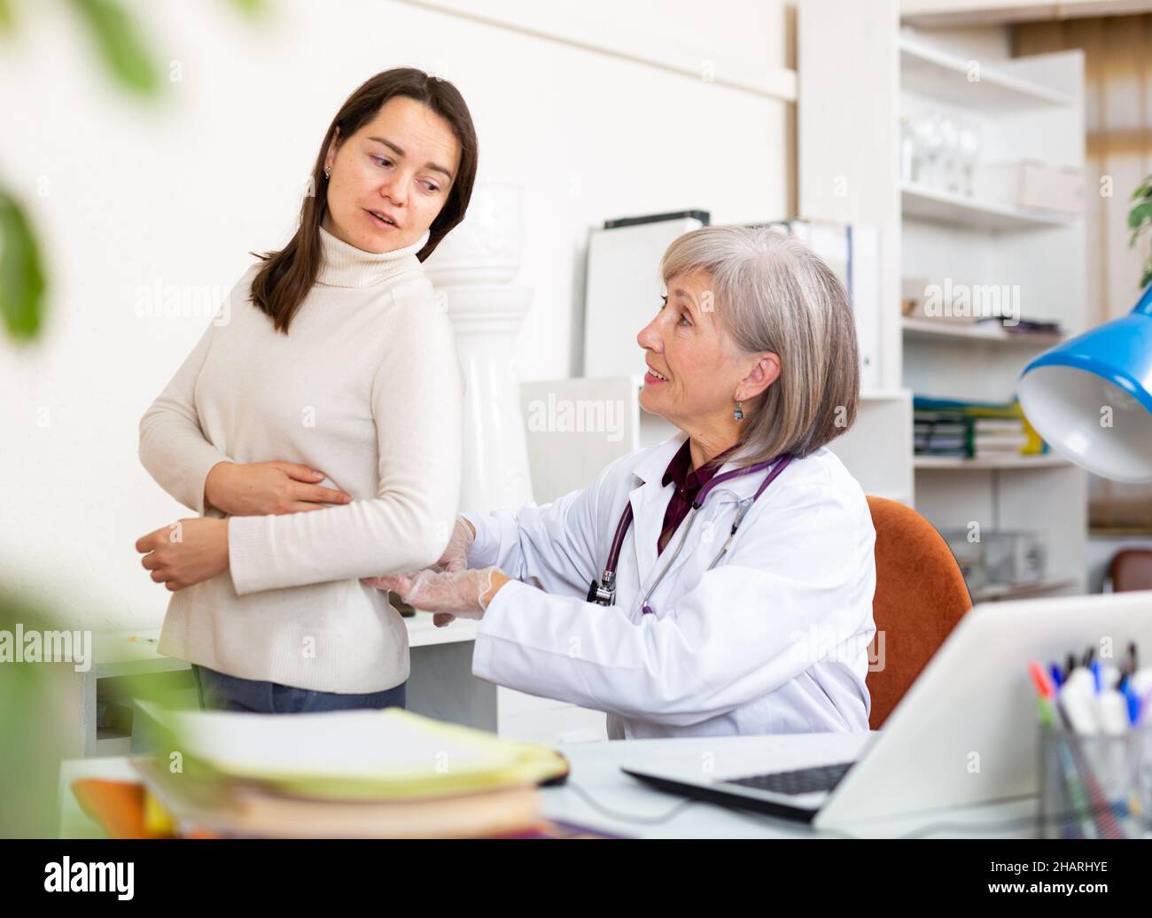 Doctor consulting patient with back pain Stock Photo - Alamy