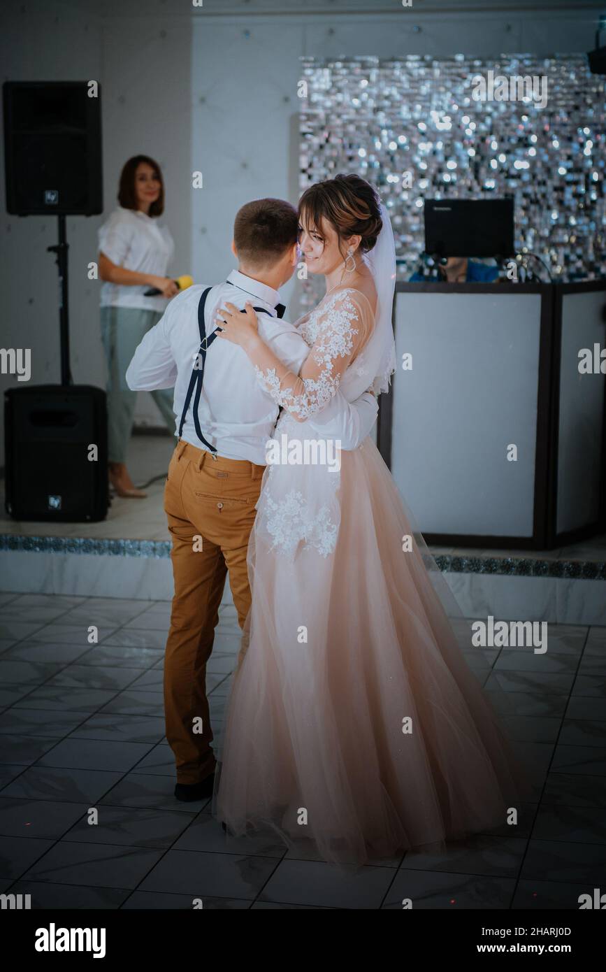 beautiful caucasian couple just married and dancing their first dance ...