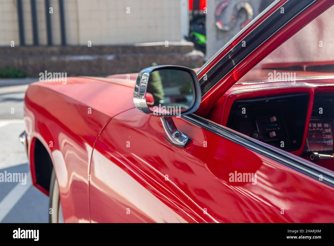 The vehicle's wing mirror of a red classic car or Muscle car Stock ...