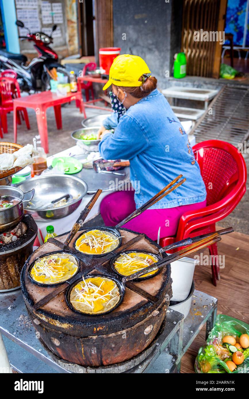 Lady Cooking Street food breakfast with mini skillet eggs Stock Photo ...