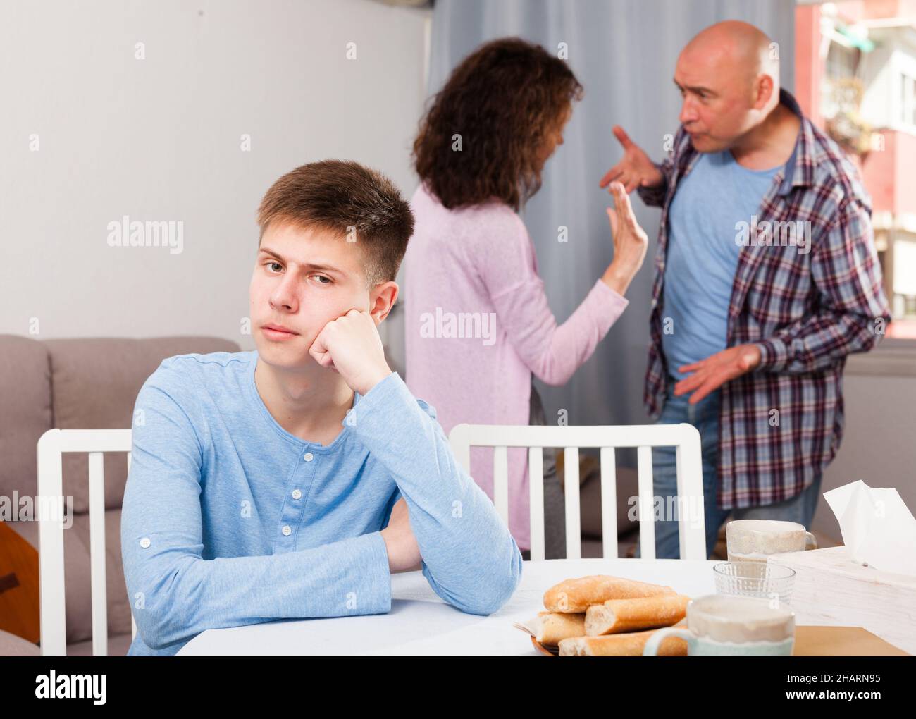 Son suffering from parents conflicts Stock Photo - Alamy