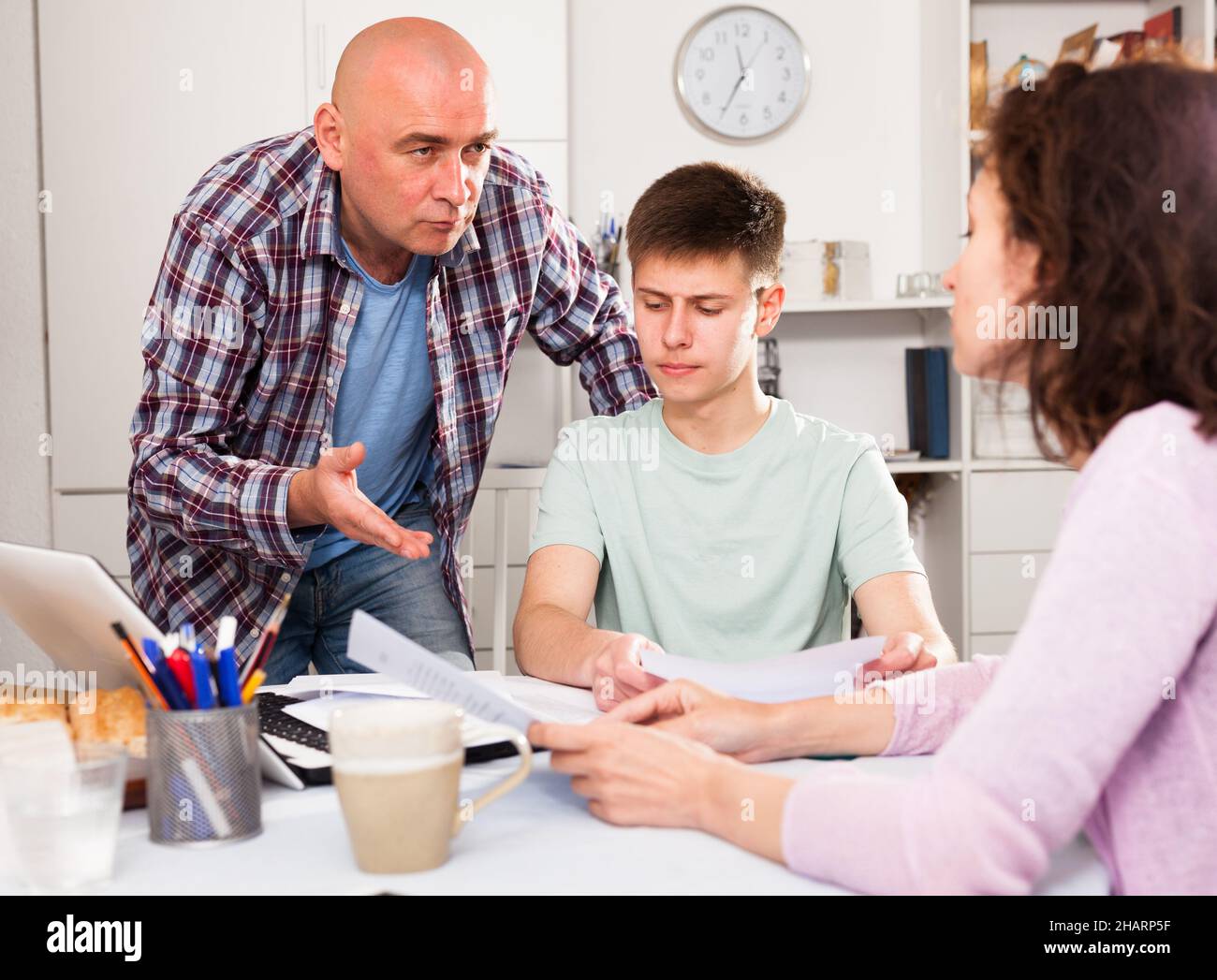 Family with son working with papers Stock Photo - Alamy