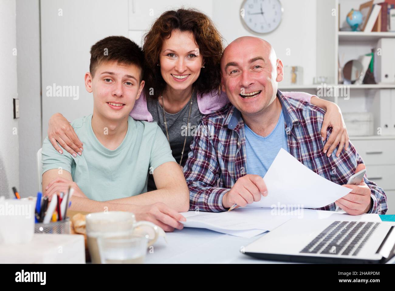 Happy family with papers Stock Photo - Alamy
