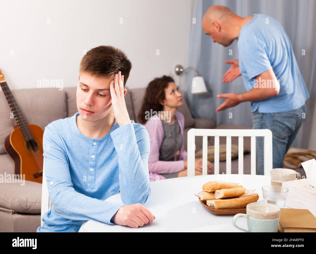 Son suffering from parents conflicts Stock Photo - Alamy